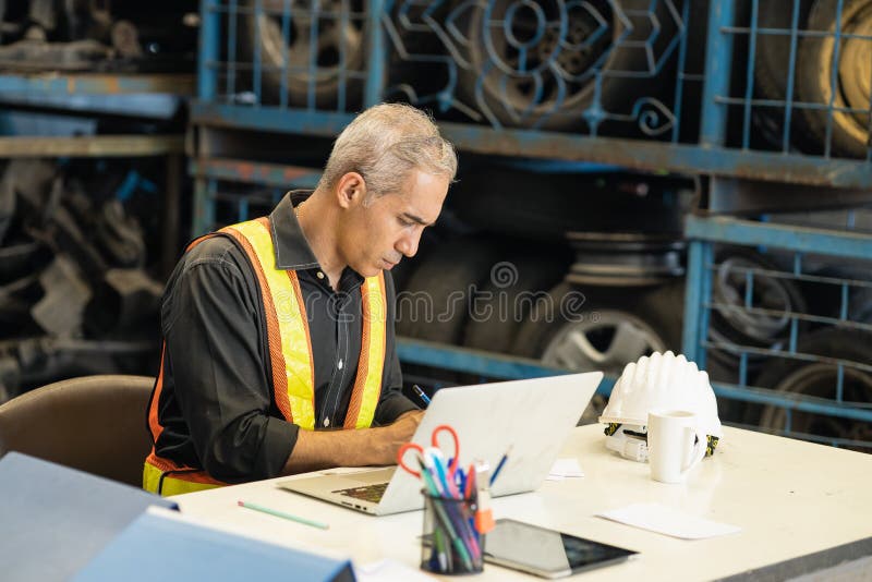 Professional Engineer Foreman Working Intense at Desk Seriously Look ...