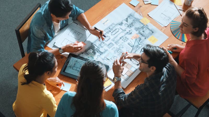 Professional Engineer Handed Document while Looking at Blueprint ...