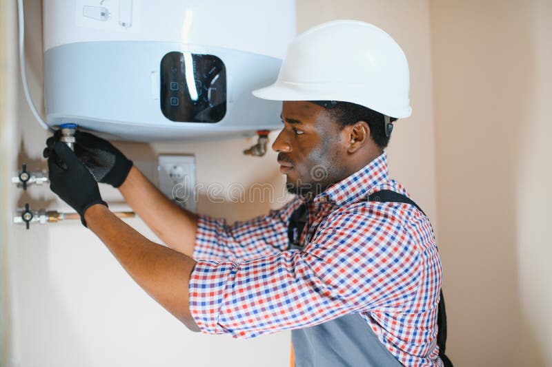 Professional Engineer Installing a Natural Gas Boiler at Home, he is ...