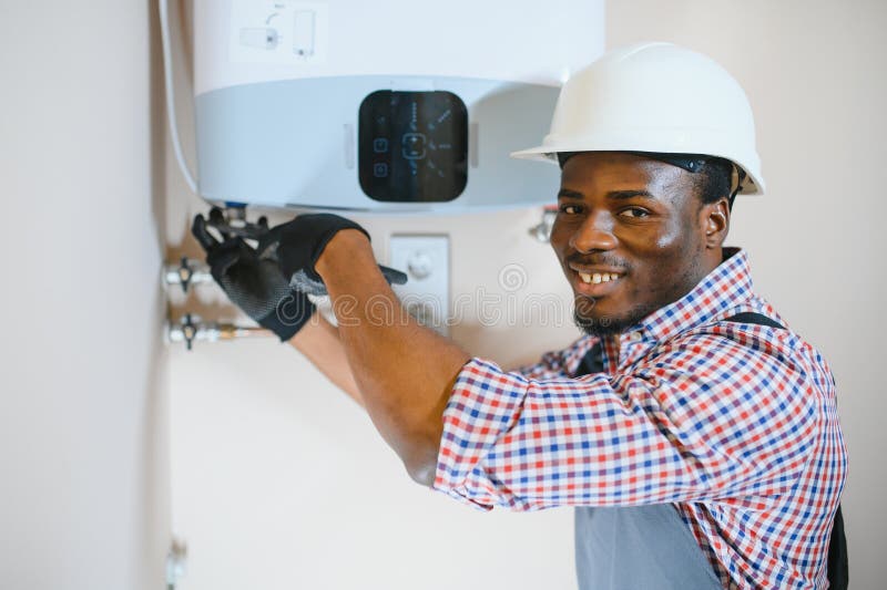 Professional Engineer Installing a Natural Gas Boiler at Home, he is ...