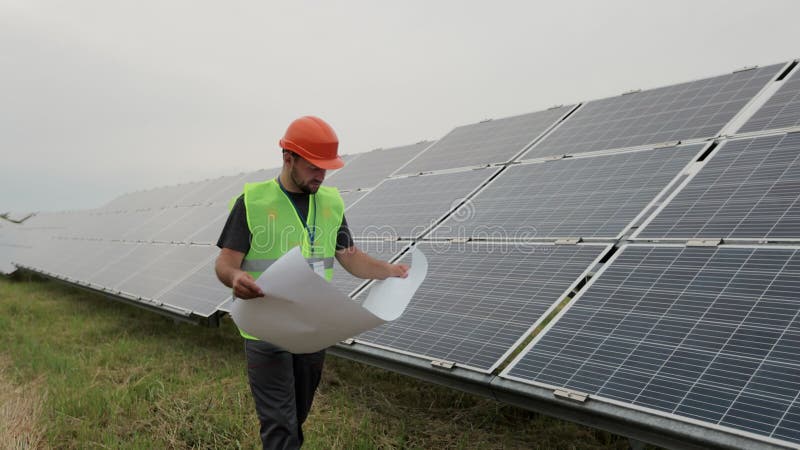 Professional Engineer Learning the Design of the Solar Plant Paper Plan ...
