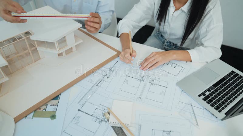 Engineer Measures Model while Skilled Designer Writes at Blueprint ...