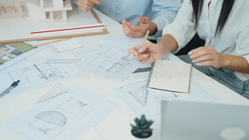 Engineer Measures Model while Skilled Designer Writes at Blueprint ...