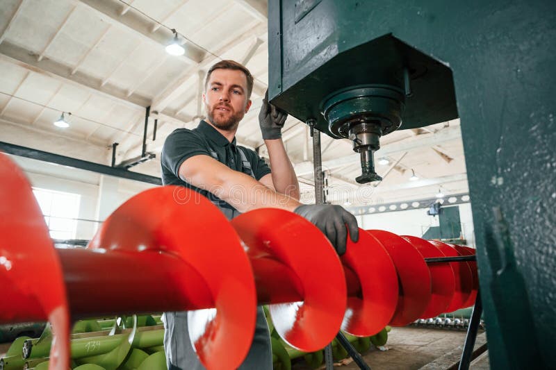 Professional Engineer Operating Machine. Man in Uniform is in ...