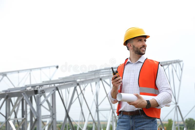 Professional Engineer with Plan and Walkie Talkie Near High Voltage ...