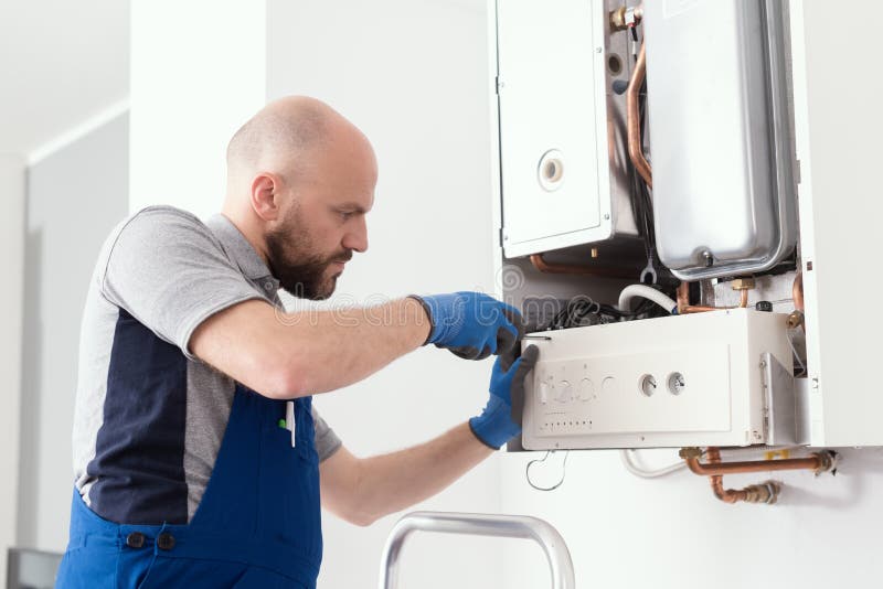 Professional Engineer Servicing a Boiler at Home Stock Image - Image of ...
