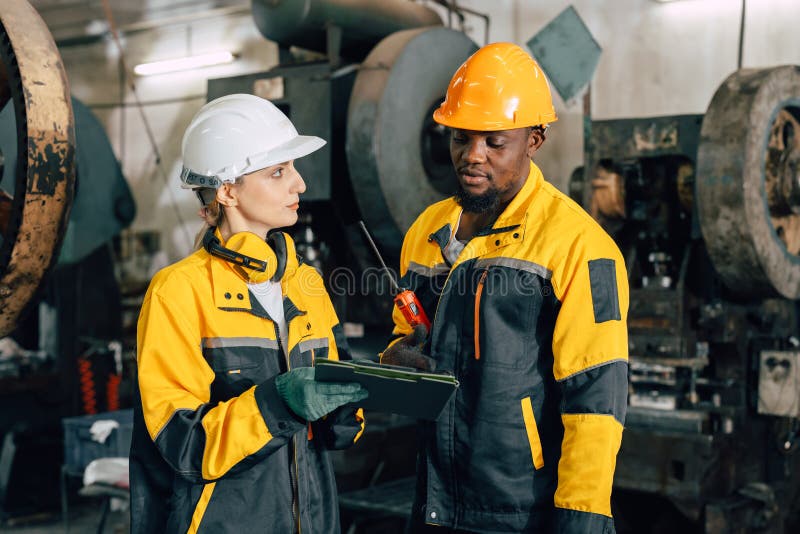 Professional Engineer Team Inspecting Service Machine in Heavy Industry ...