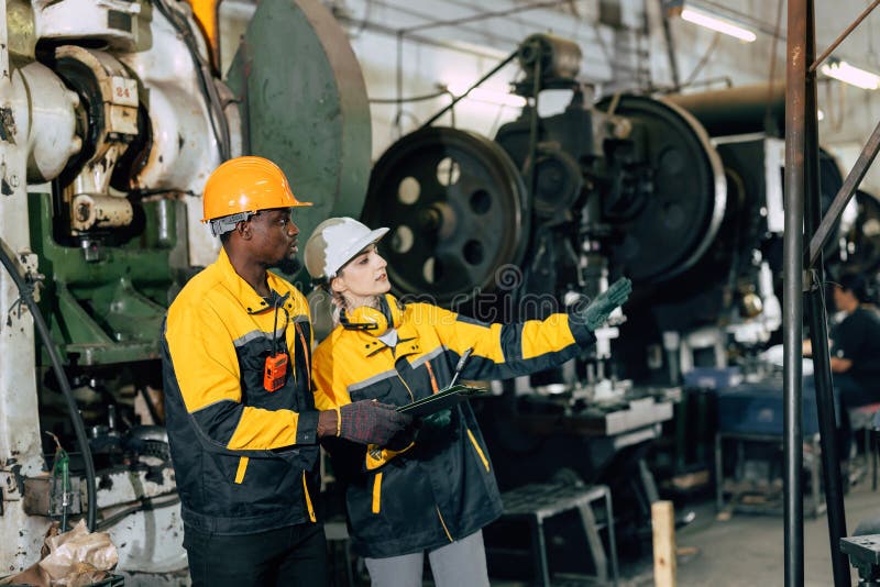 Professional Engineer Team Inspecting Service Machine in Heavy Industry ...