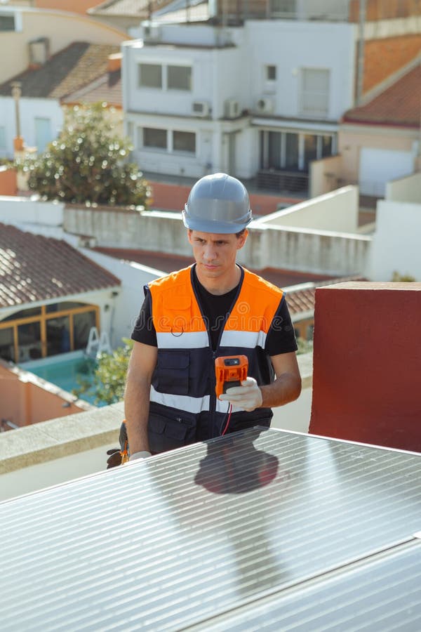 Professional Engineer Worker Installing Solar Panels on a House Roof ...