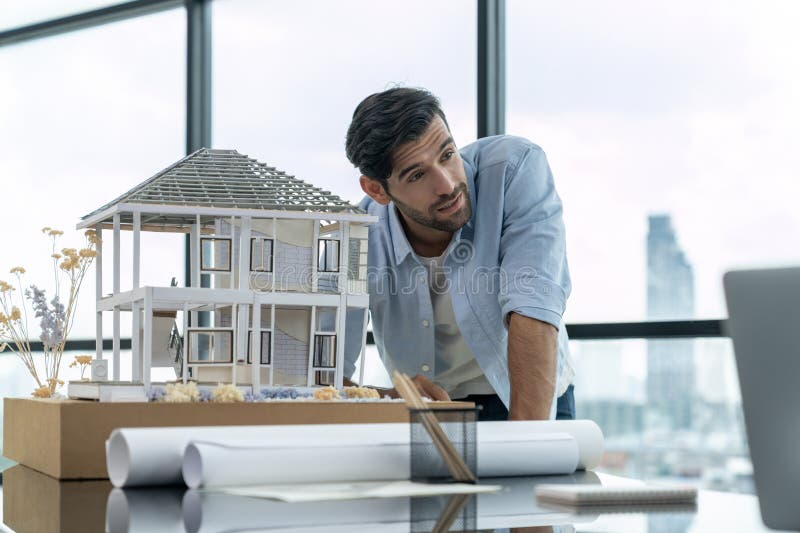 Professional Engineer Working with House Model Turning Face at Laptop ...