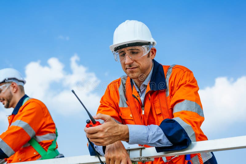 Professional Engineers Technicians Working at Wind Turbine Farm Field ...