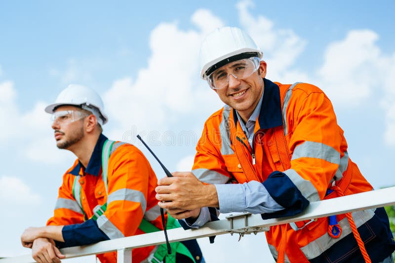 Professional Engineers Technicians Working at Wind Turbine Farm Field ...
