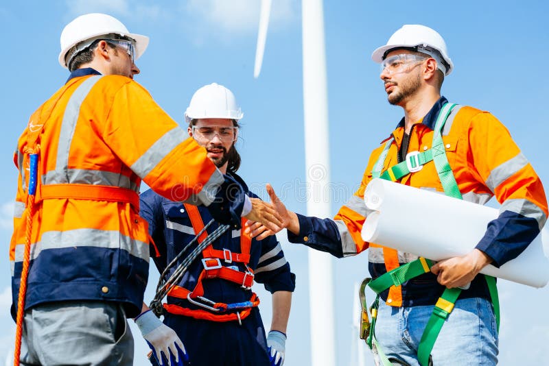 Professional Engineers Technicians Working at Wind Turbine Farm Field ...