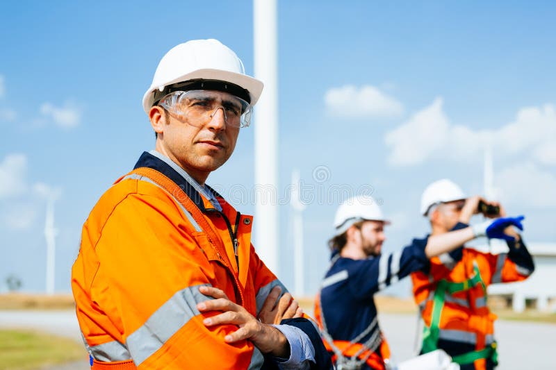 Professional Engineers Technicians Working at Wind Turbine Farm Field ...