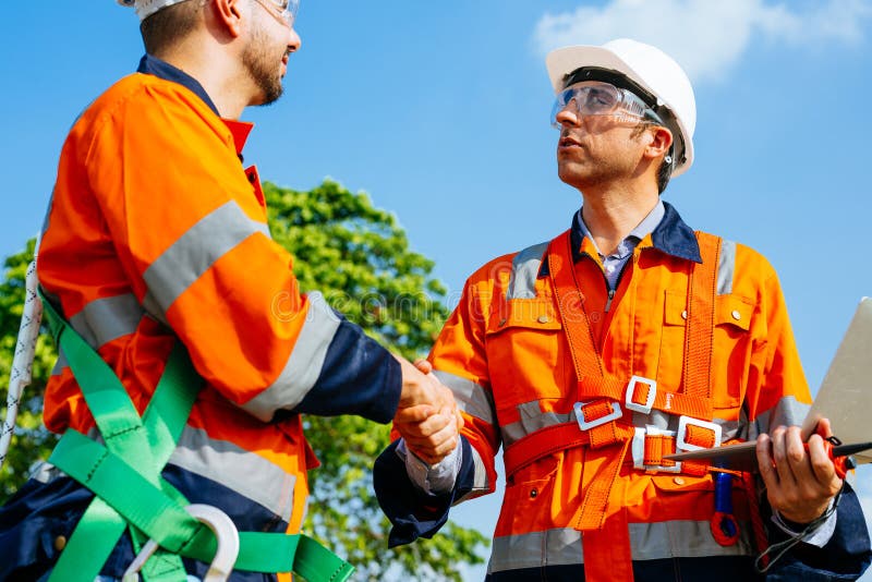 Professional Engineers Technicians Working at Wind Turbine Farm Field ...