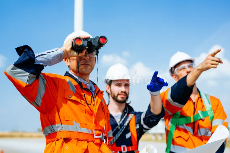 Professional Engineers Technicians Working at Wind Turbine Farm Field ...