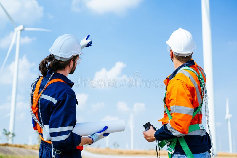 Professional Engineers Technicians Working at Wind Turbine Farm Field ...