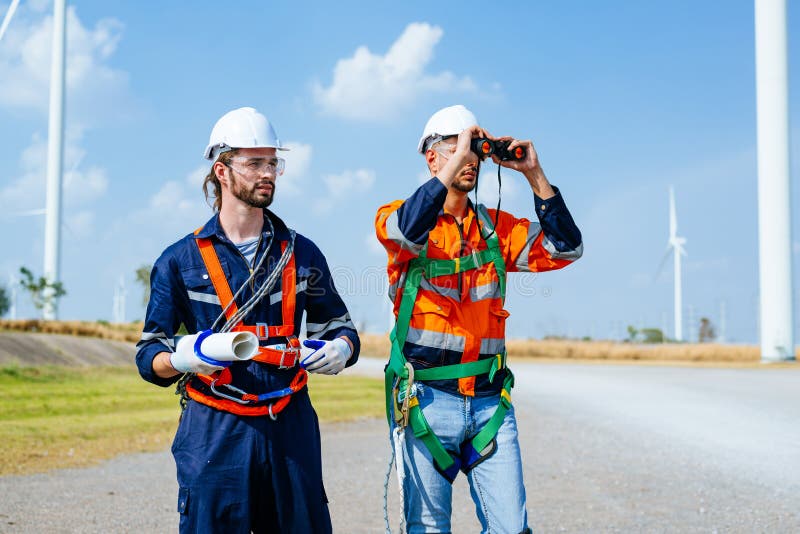 Professional Engineers Technicians Working at Wind Turbine Farm Field ...