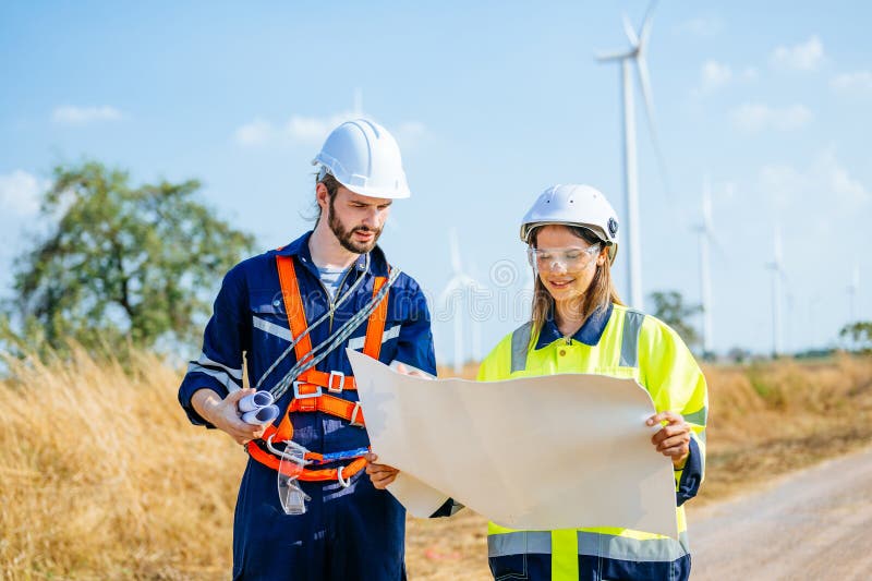 Professional Engineers Technicians Working at Wind Turbine Farm Field ...
