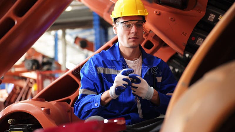 Engineers Working with Machine Robotic Arms at Industrial Factory Stock ...