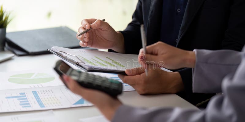 Analysis and Review. Colleagues Analyzing Business Performance during a ...