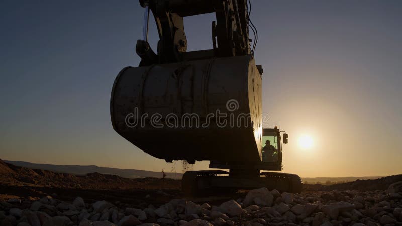 Professional Excavator Dumping Large Rocks during Sunset Light at ...