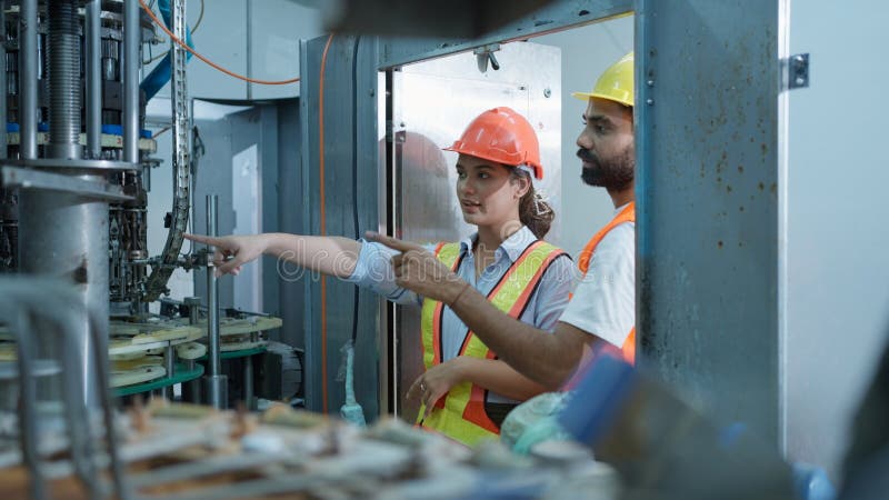 Professional Factory Manager Checking and Controlling Machine at ...