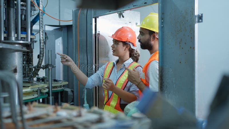 Professional Factory Manager Checking and Controlling Machine at ...