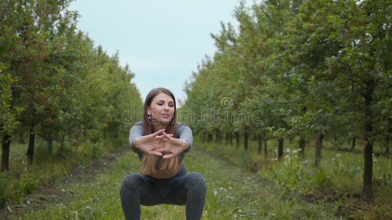 Professional Female Athlete Training Outdoors Doing Jumping Squats To