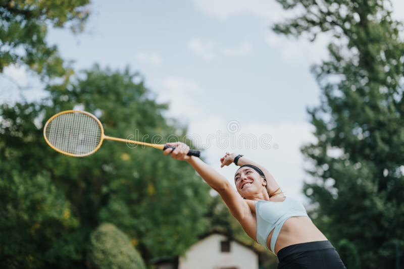 Professional, Female, Badminton Player Reaching for a Shuttlecock with ...