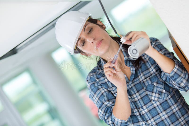 Female Cctv Installer Hinstalling Security Camera Stock Photo - Image ...