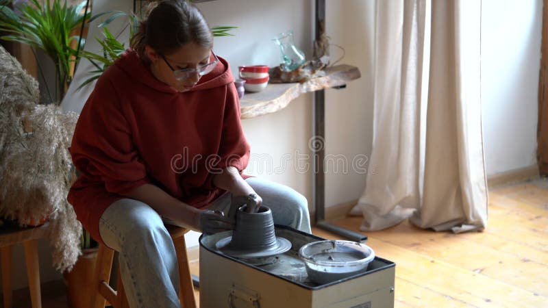 Professional Female Ceramic Artist Teaching Students How To Use Pottery ...