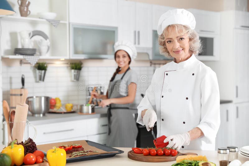 Professional Female Chef Cutting Pepper on Table Stock Image - Image of ...