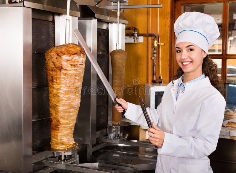 Professional Female Cook with Grilled Meat on Spit for Kebab Stock ...