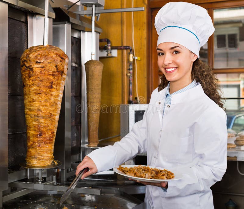 Professional Female Cook with Grilled Meat on Spit for Kebab Stock ...