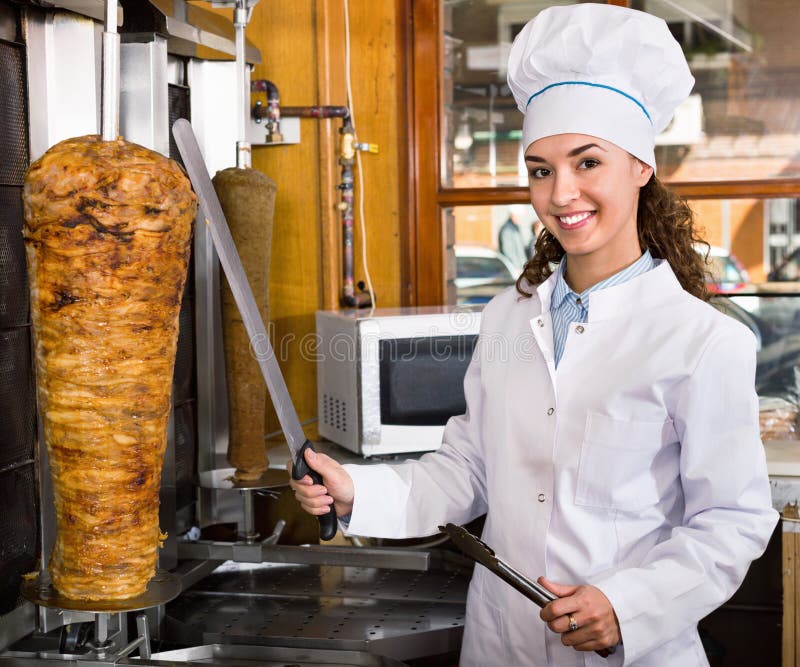 Professional Female Cook with Grilled Meat on Spit for Kebab Stock ...