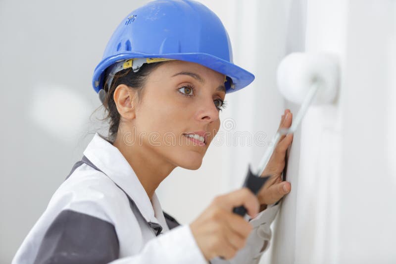Professional Female Decorator Using Paint Roller Stock Photo - Image of ...