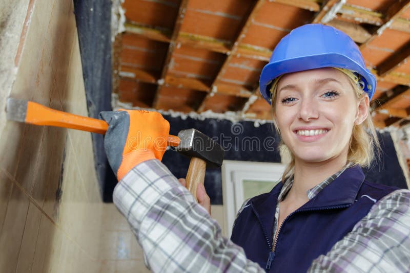 Professional Female Labourer Using Hammer and Chisel Stock Photo ...