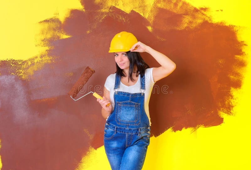 Professional Female Painter in a Construction Helmet with a Paint ...