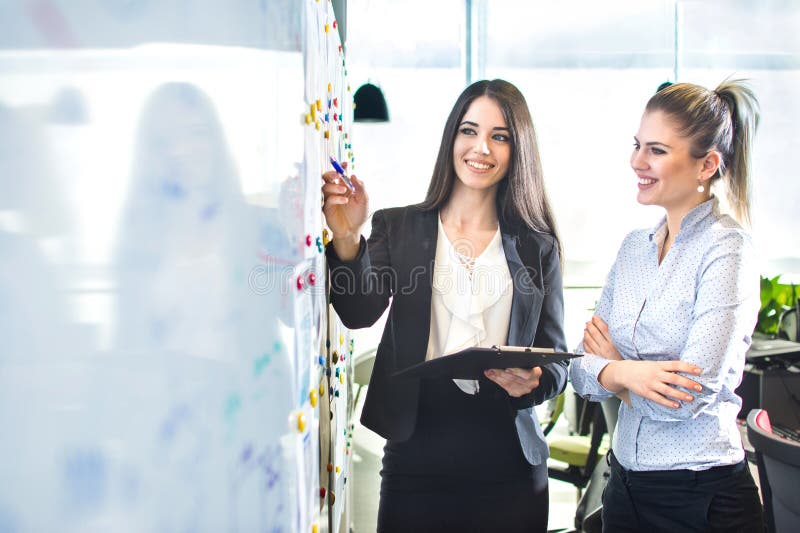 Professional Female Staff Analyzing Strategy of Their Work on ...