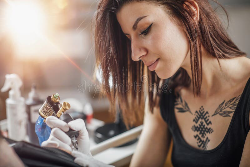 Professional Female Tattooist Working in a Tattoo Studio Stock Image ...