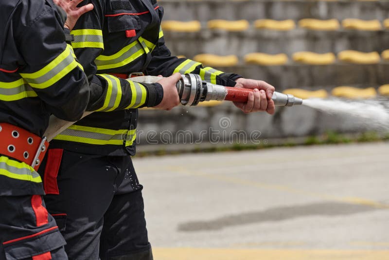 Professional Firefighters Training with Water Hose Stock Photo - Image ...
