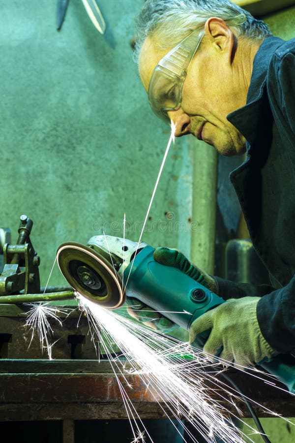 Professional Fitter in Protective Gloves and Uniform Using Gringer Tool ...