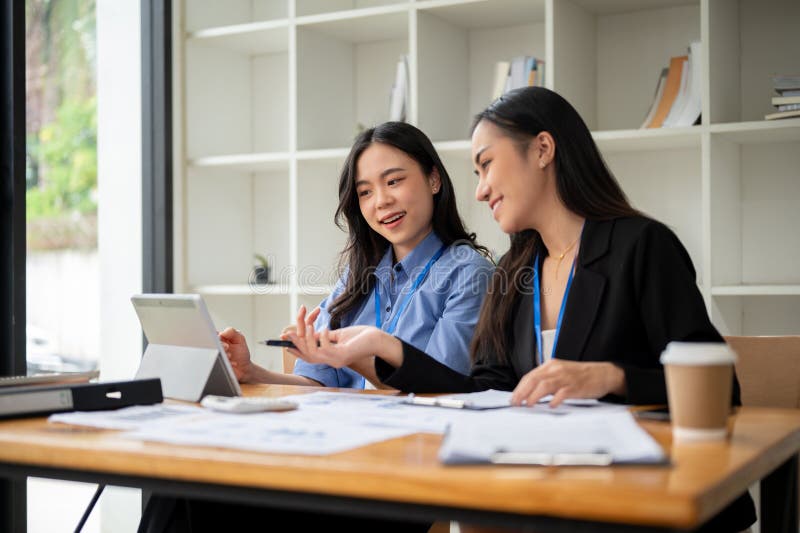 A Professional and Friendly Asian Female Office Worker is Explaining ...