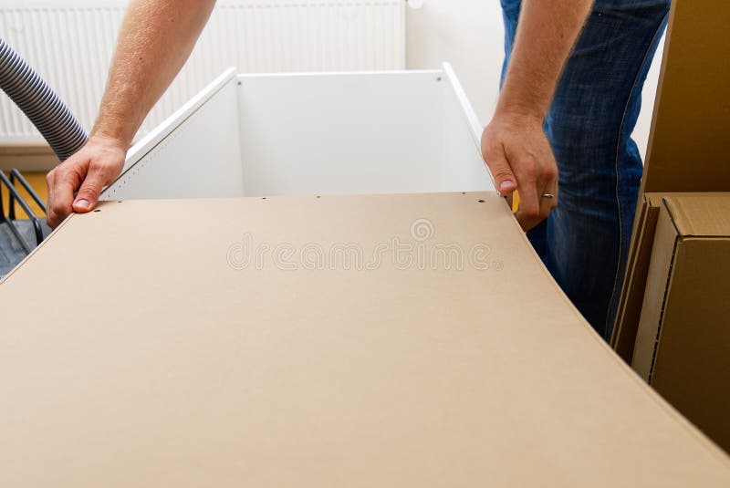 Professional Furniture Assembly Worker Assembles Shelf. Furniture ...