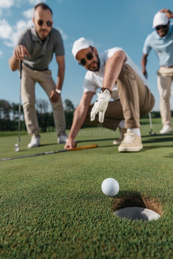 Professional Golf Players Looking at Ball Near the Hole Stock Photo ...