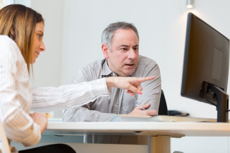 Professional Graphic Designer Showing Computer To Client Stock Photo ...