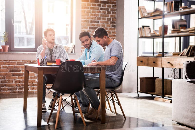 Professional Group Sitting at Table and Working on New Business Project ...
