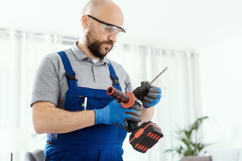 Professional Handyman Using a Drill Stock Photo - Image of domestic ...