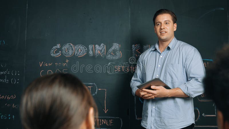 Caucasian Teacher Answering Student Question about Coding Program ...